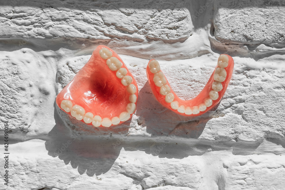 Full removable plastic denture of the jaws. A set of dentures on a ...