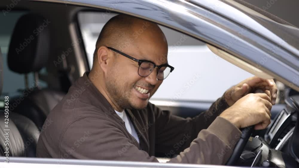 Young asian men around 30 getting new car. He very happy and excited ...