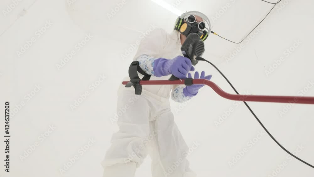 Clouse-up of man in white chemical protection suit, gas mask and purple ...