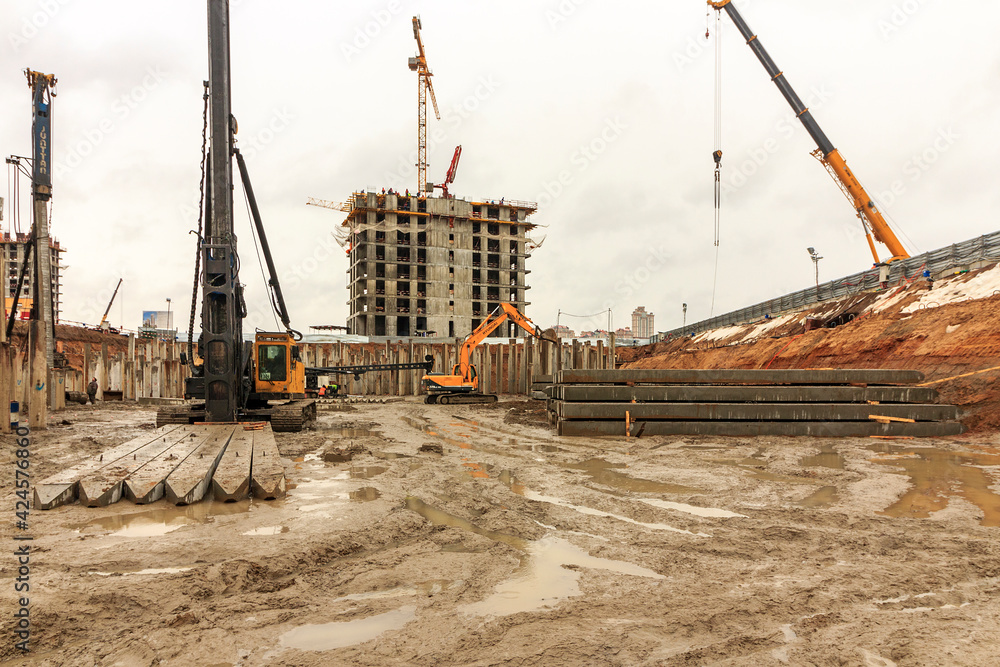Pile driving in foundation pit for construction of apartment building ...