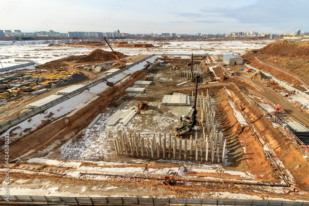 Reinforced concrete piles of new building, tower crane. Hydraulic ...