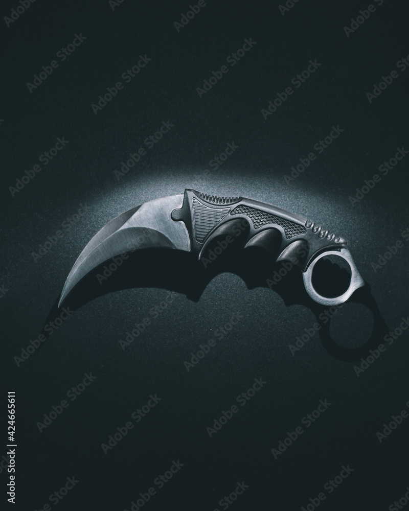 Top down photo of a knife, karambit. Stock Photo | Adobe Stock