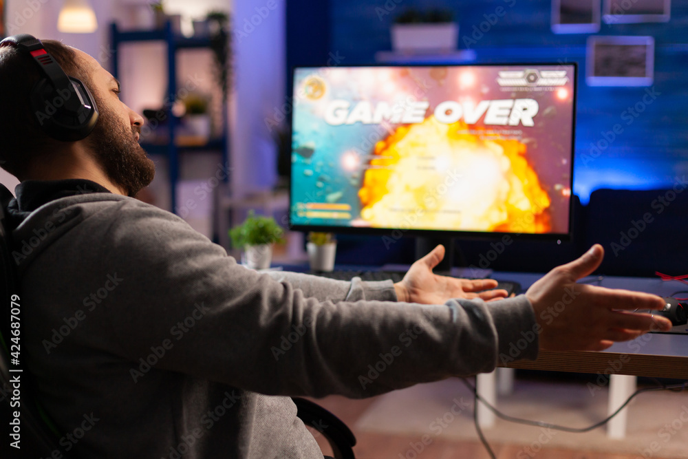 Game over for gamer playing videogames on computer during night time in ...