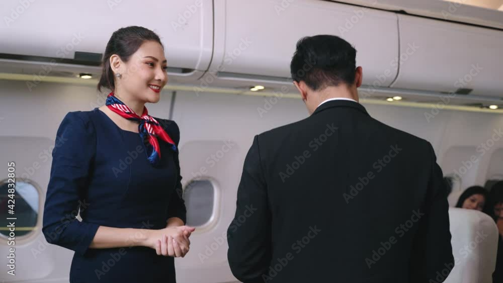 Beautiful woman cabin crew is smile greeting to passengers onboard ...