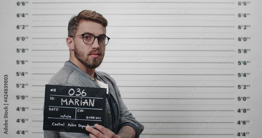 Side profile mugshot of man with beard and mustache holding sign . Male ...