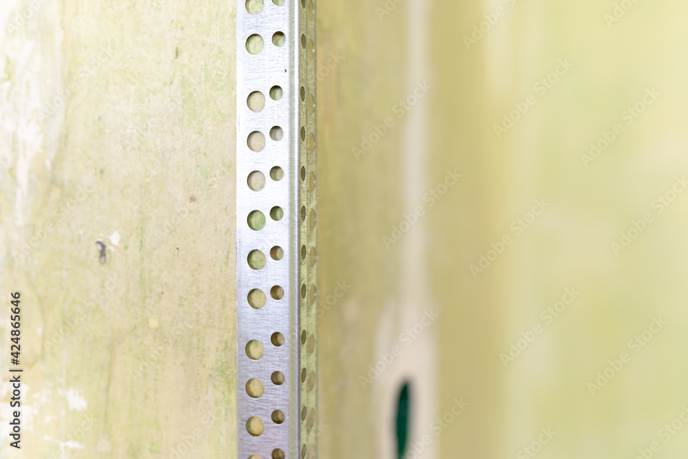 Perforated metal corner covered with plastic plaster. Construction ...