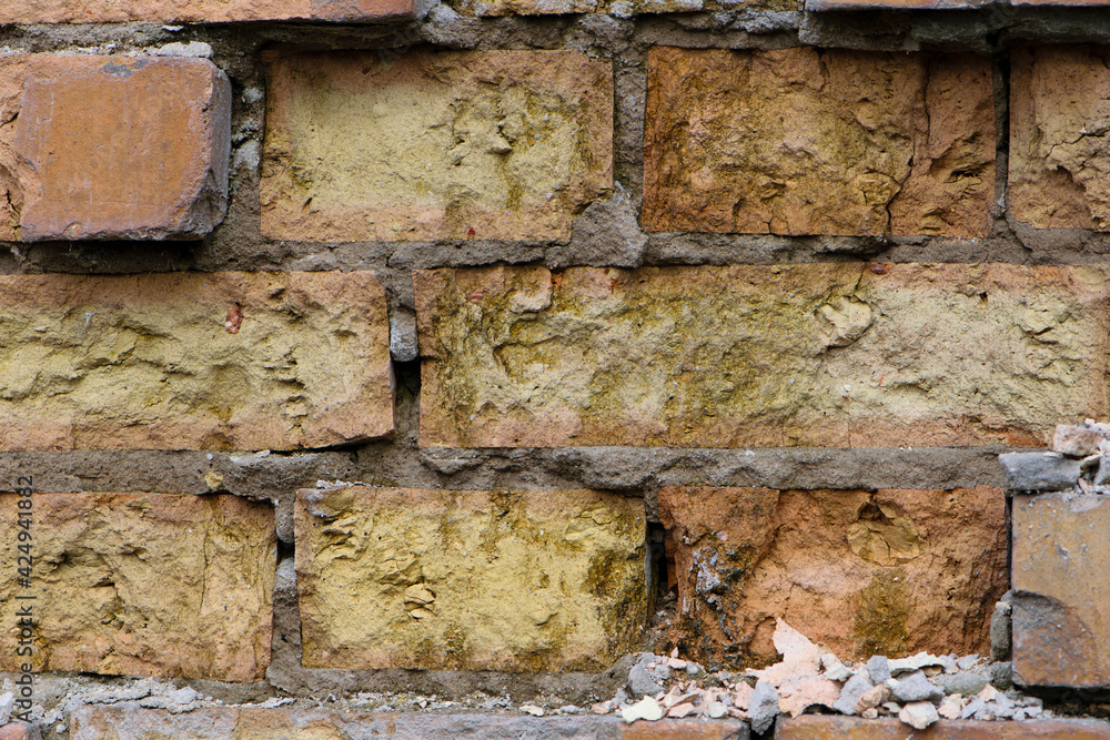 old brick wall. Decorative wall made of destroyed dark red bricks ...