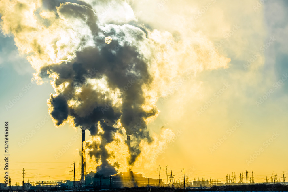 Sunset over the industrial city.Factory chimneys smoke.Environmental ...