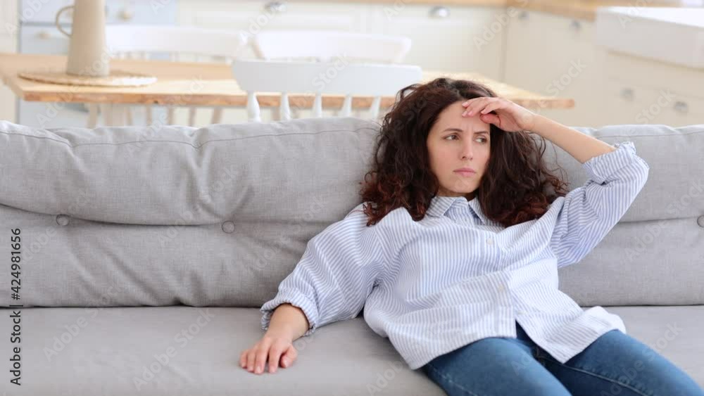 Exhausted sad woman lying on sofa at home feels tired after hard ...