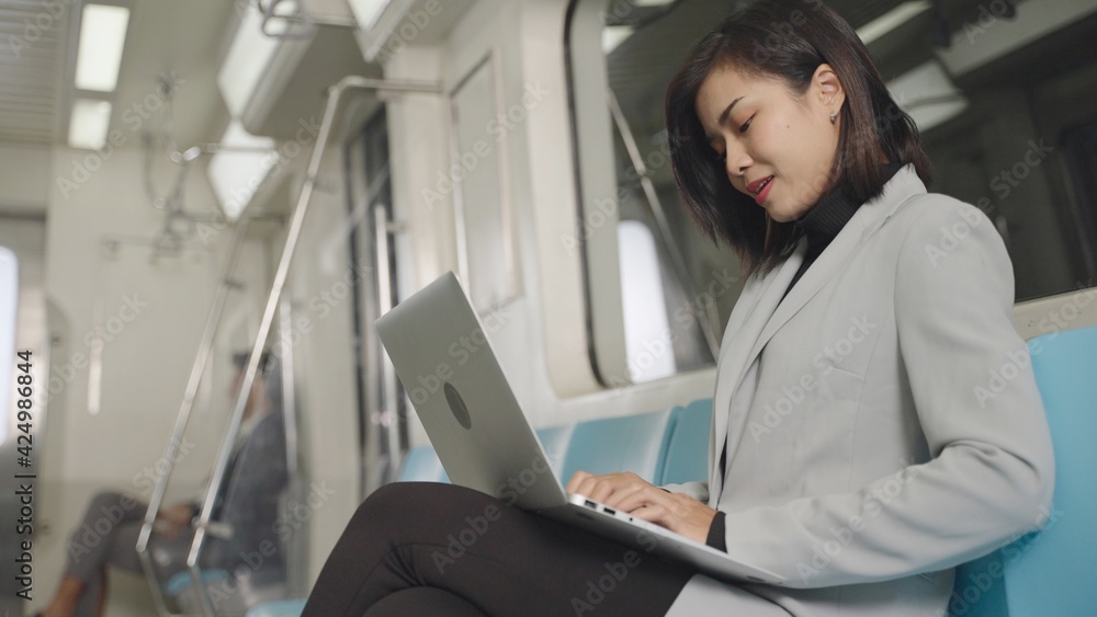 Young business girl travelling on train in night time. Woman sitting ...
