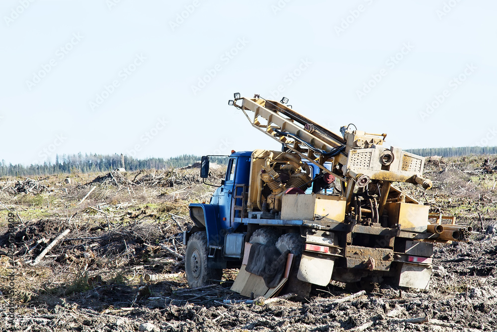 Vehicle-based drilling rig, wagon drill on the site of the sawn forest ...