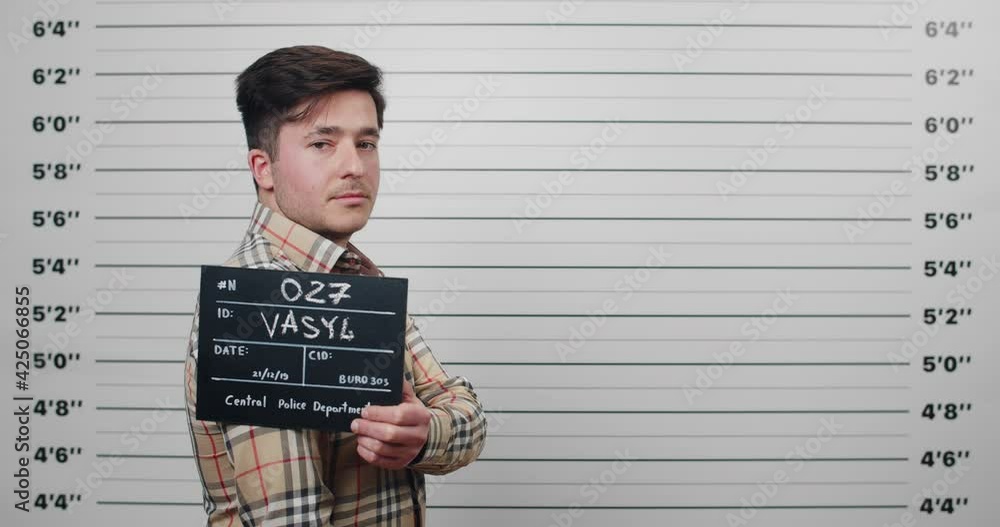 Vídeo do Stock: Side profile mugshot of male arrested looking to camera ...