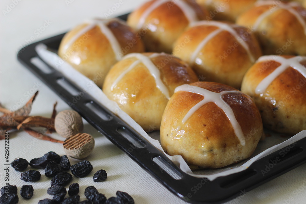Freshly baked hot cross buns. A sweet fruit bun lightly spiced with cinnamon and nutmeg and ...