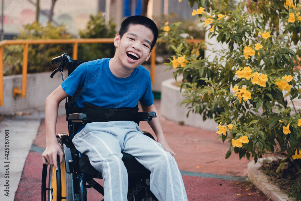 Asian special child on wheelchair is smiling face as happiness on the ...