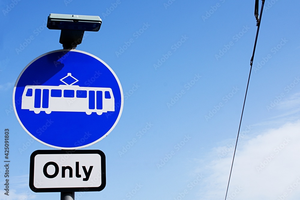 UK road sign, blue round Trams only traffic sign. Stock Photo | Adobe Stock