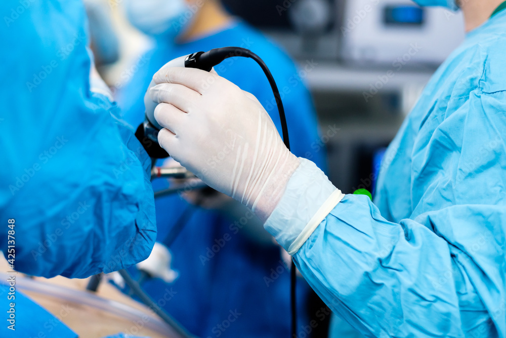 Selective focus on the hand of a surgeon wearing a sterile latex glove ...