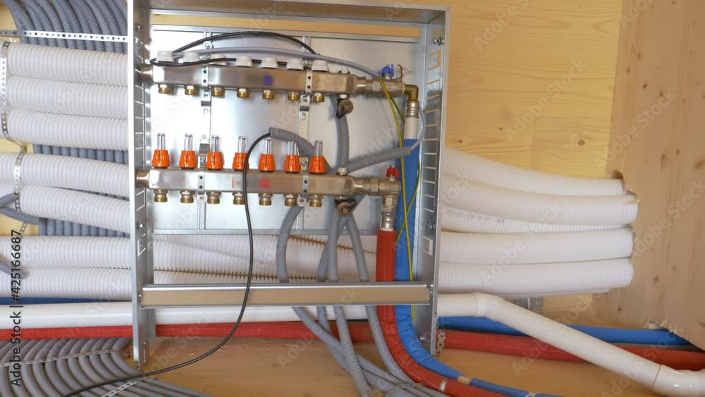 CLOSE UP: Colorful corrugated water and electricity tubing runs past ...