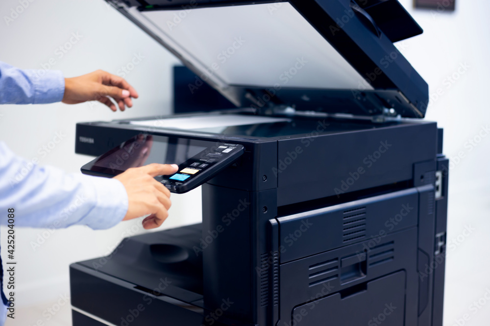 Bussiness man Hand press button on panel of printer, printer scanner ...