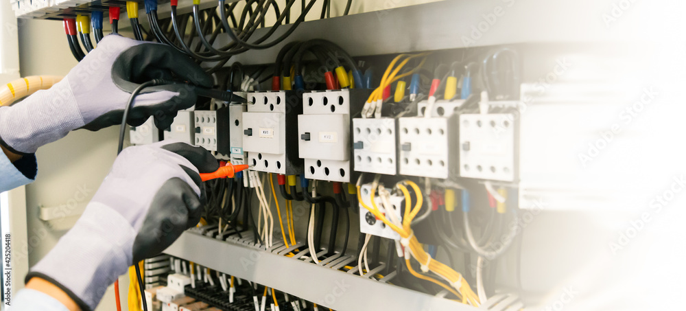 Fotka „Electrical engineers test electrical installations and wiring on ...