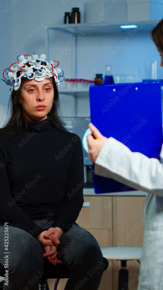 Neuroscience doctor holding clipboard showing treatment against brain ...