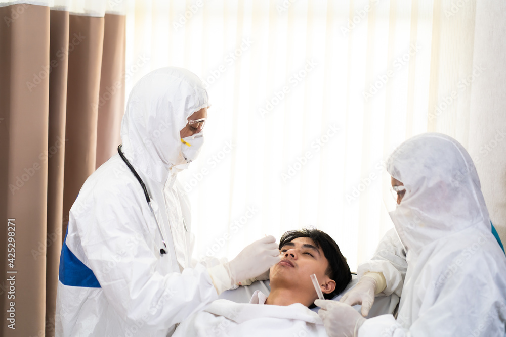 Two medical technicians wearing full protective equipment collected ...