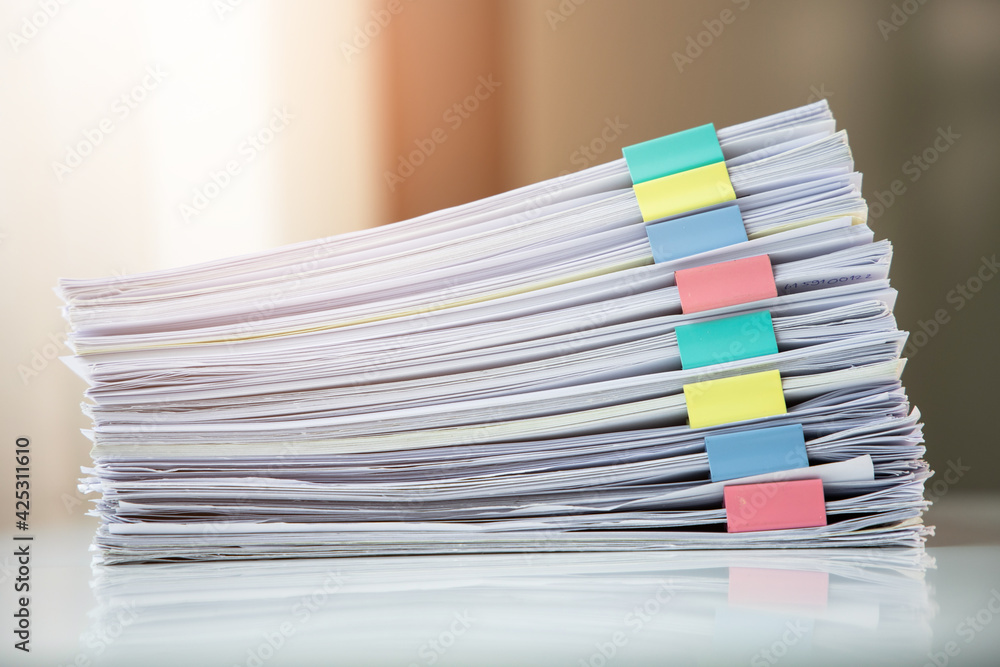Piles of white papers work large piles of papers stacked together. On ...