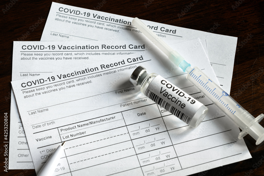 COVID-19 Vaccination Record Card on desk, coronavirus immunization ...