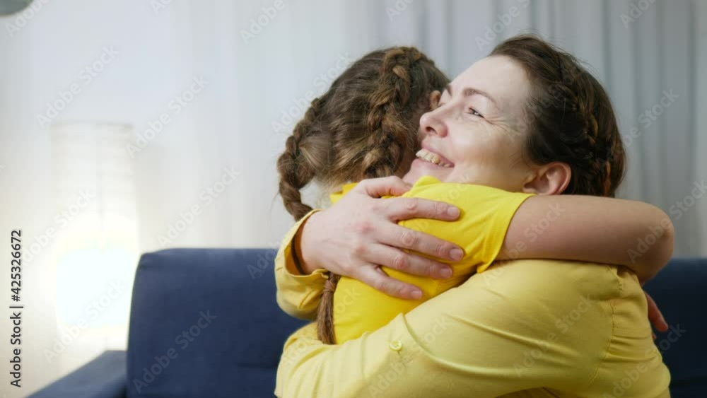 daughter hugs mom. happy family a lockdown stay home concept. mom and ...