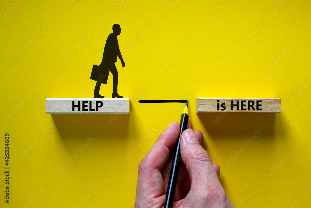 Help is here symbol. Wooden blocks with words 'Help is here' on ...
