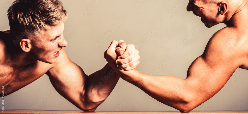 Rivalry, vs, challenge, strength comparison. Two men arm wrestling ...