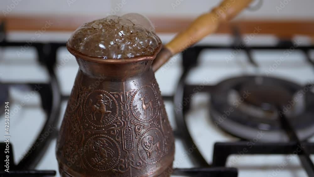 Brewing Ground Turkish Coffee in a Copper Turk on a Gas Stove. Boiling ...