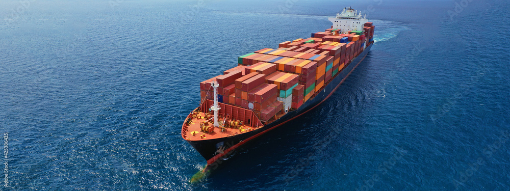 Aerial drone ultra wide photo of huge container ship cruising deep blue ...