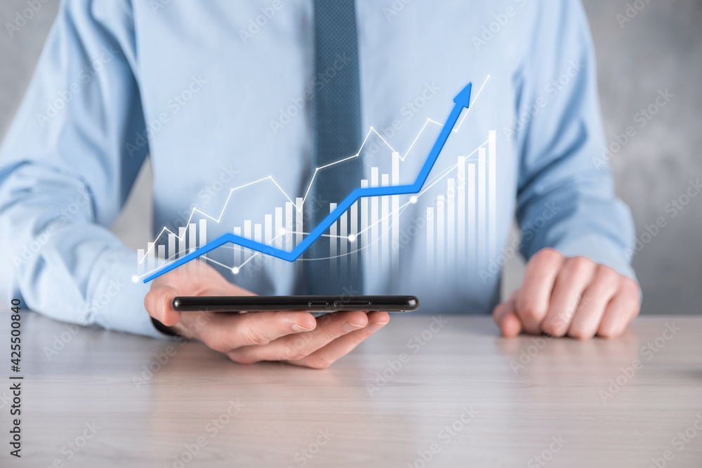 Businessman man holding a graph with positive profits growth. plan ...