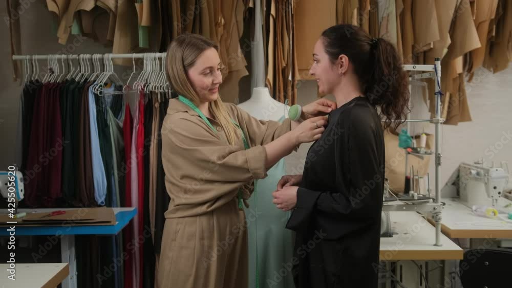 Video Stock Femail seamstress taking measurements of female client ...