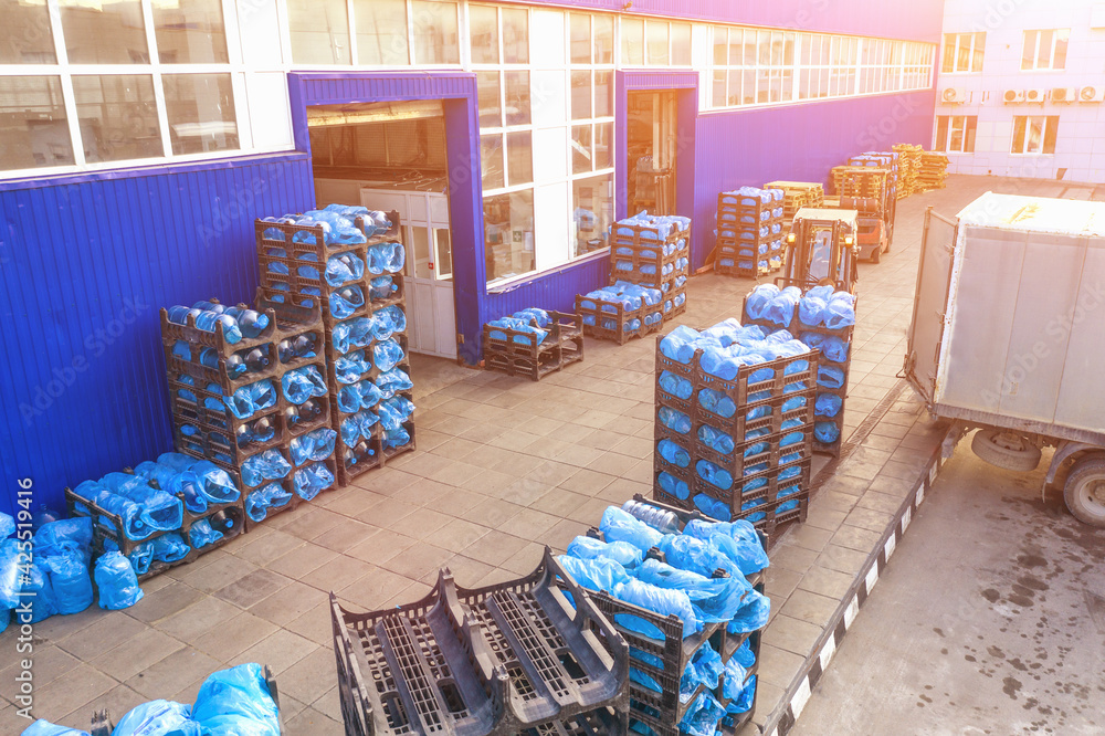 Warehouse with open gates and goods in pallets ready for loading and ...