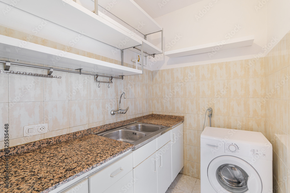 Old empty kitchen with shelves, tiled walls, marble countertop and ...