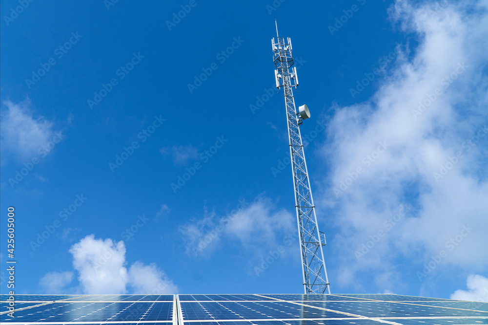 Solar panels and cell towers with a clear sky Stock Photo | Adobe Stock