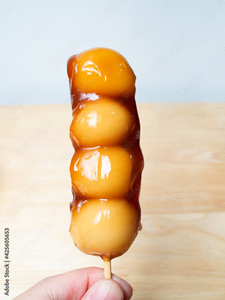 Japanese traditional food sweet mitarashi dango. (Hand Holding Dango ...