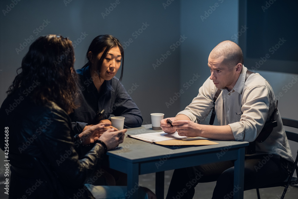 At the police station, two officers are interrogating the captured ...