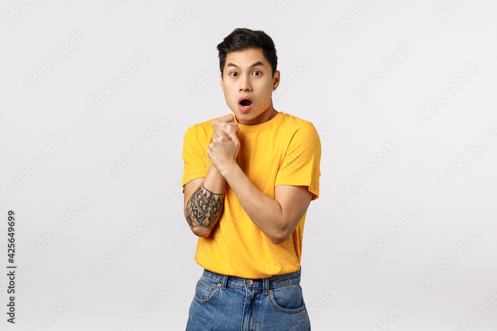 Sensetive and shocked, scared young asian guy with tattoos, pull hand ...