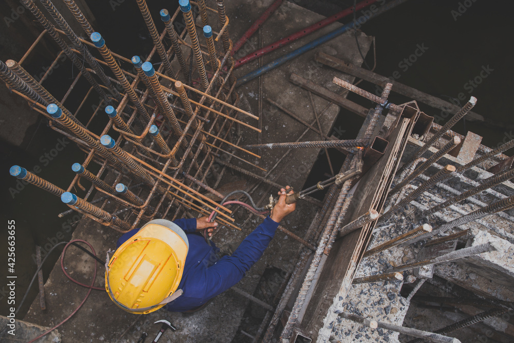 Construction workers assembling a concrete column formwork in the ...