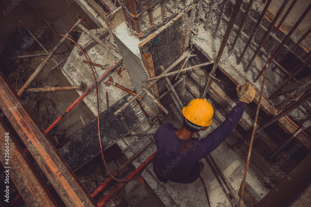 Construction worker demolishing concrete wall formwork. Stock Photo ...