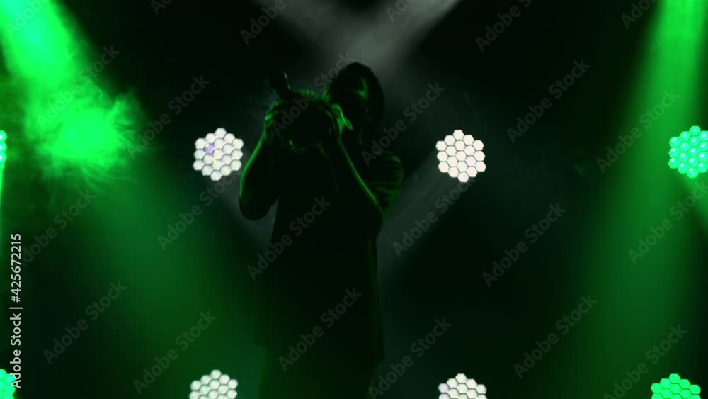 Ethnic black musician plays the African Shekere rhythm instrument and ...