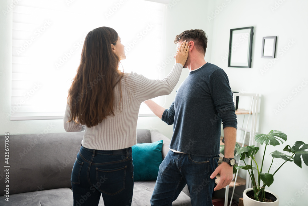 Angry girlfriend hitting her boyfriend on the face during a discussion ...