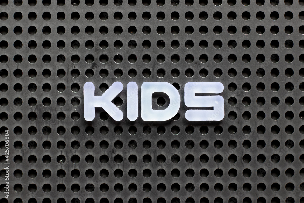 White color letter in word kids on black pegboard background Stock ...