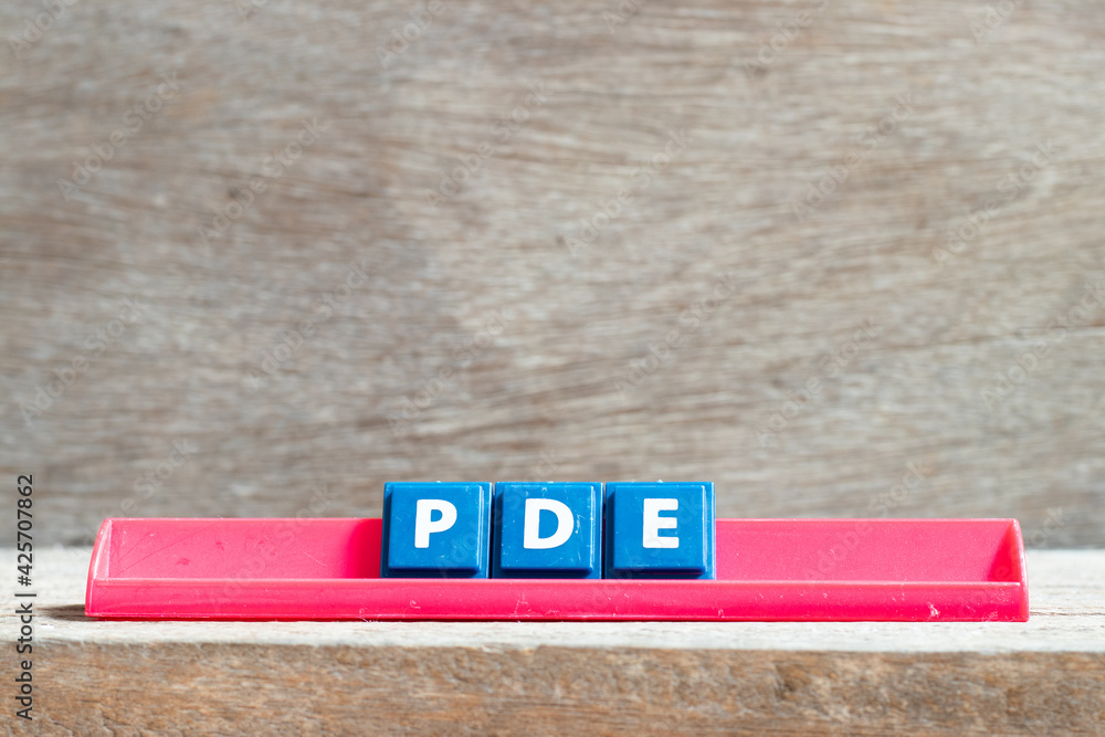 Tile letter on red rack in word PDE (abbreviation of permitted daily ...
