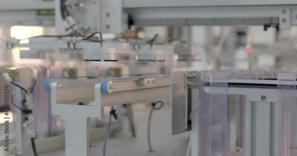 Solar panel production, clean energy, green energy. Machines in a ...