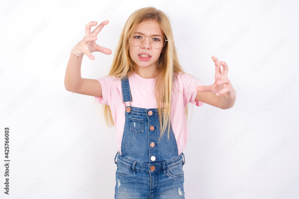beautiful caucasian little girl wearing jeans overall over white ...