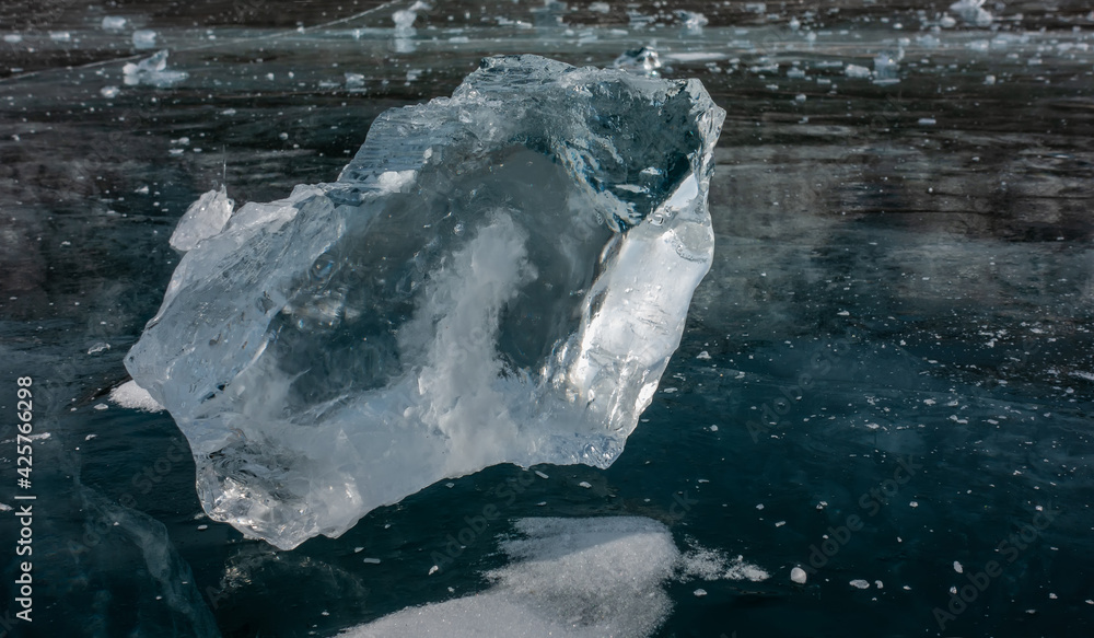 Shiny transparent shard of ice close-up. Sharp edges, bizarre shape ...