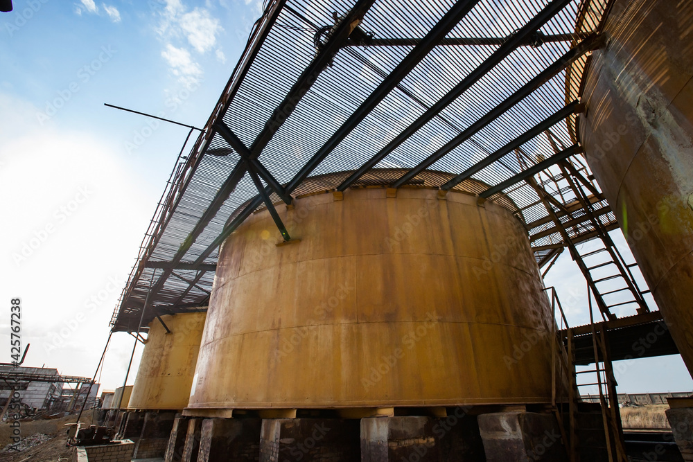 Demolition of outdated Soviet sulfuric acid plant.Old rusted yellow ...